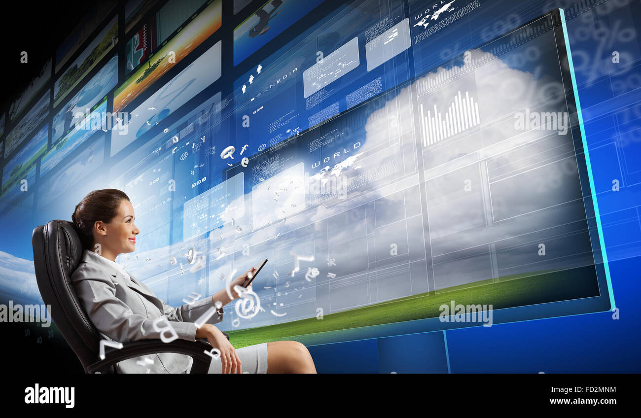 Young businesswoman in chair near tv screen with click Stock Photo - Alamy