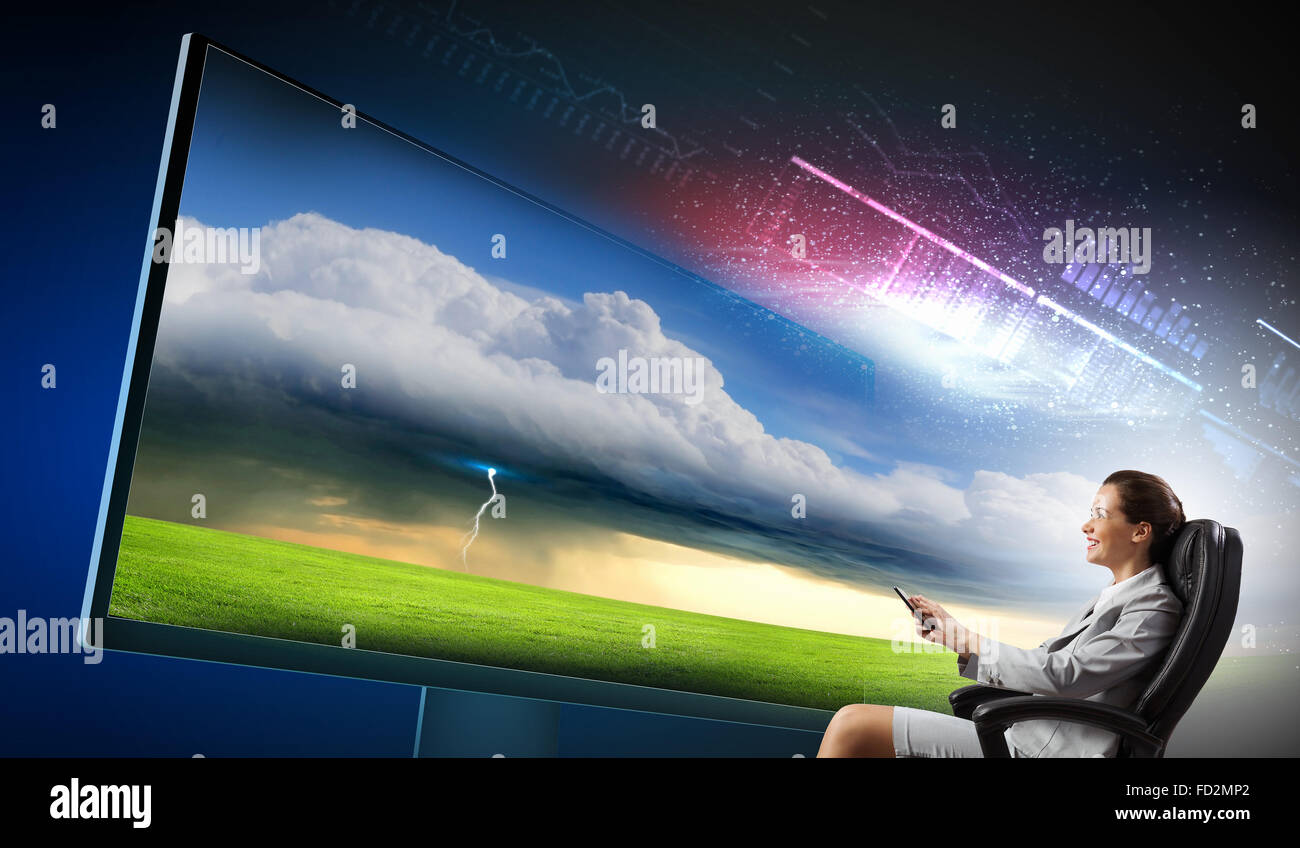 Young businesswoman in chair near tv screen with click Stock Photo - Alamy