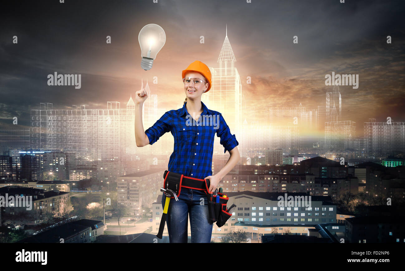 Young woman handyman pointing at electrical bulb Stock Photo - Alamy