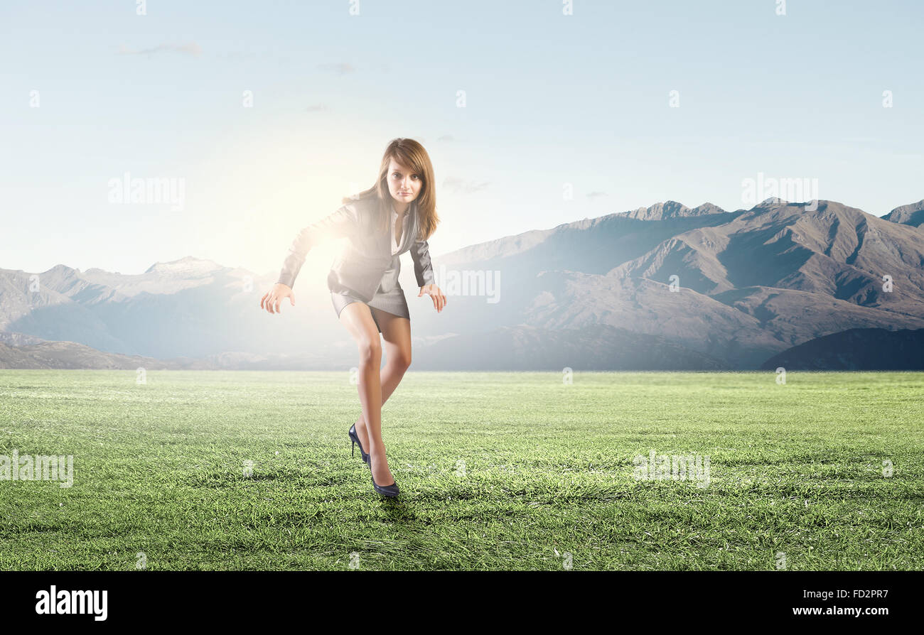 Young businesswoman in suit running on stadium track Stock Photo - Alamy