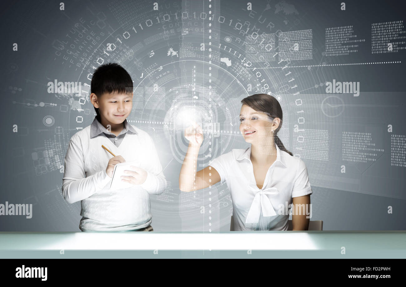 Young teacher and school boy at computing lesson Stock Photo - Alamy