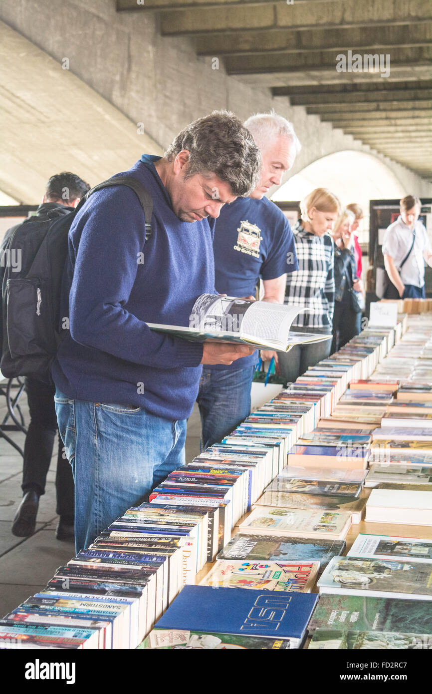Man looking to a book Stock Photo - Alamy