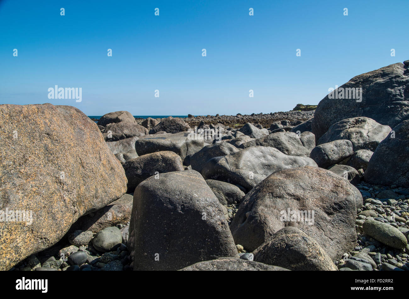 Rocks on the beach on the South West Coast Path between Porthoustock ...
