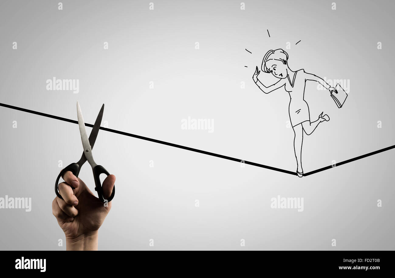 Close up of hand cutting rope with scissors Stock Photo - Alamy