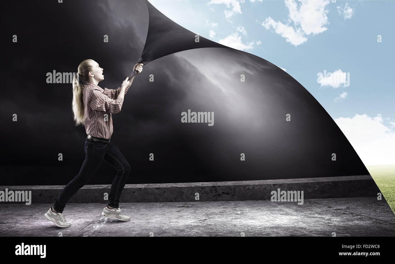 Young woman pulling page to change scene Stock Photo - Alamy