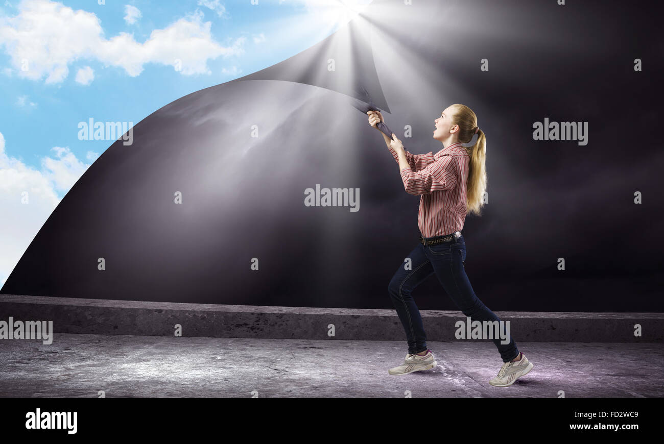 Young woman pulling page to change scene Stock Photo - Alamy