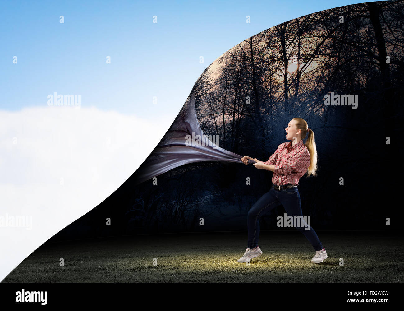 Young woman pulling page to change scene Stock Photo - Alamy