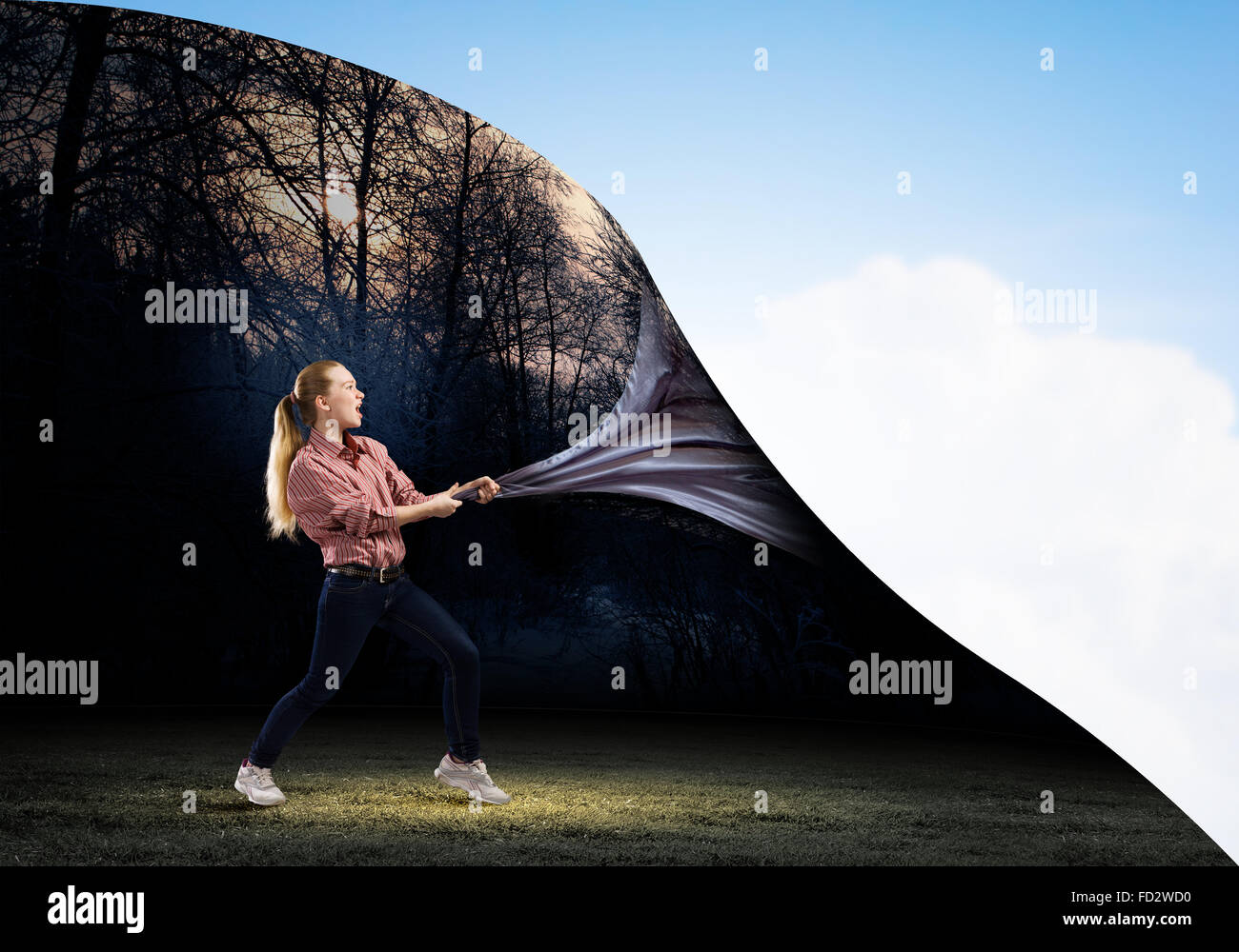 Young woman pulling page to change scene Stock Photo - Alamy