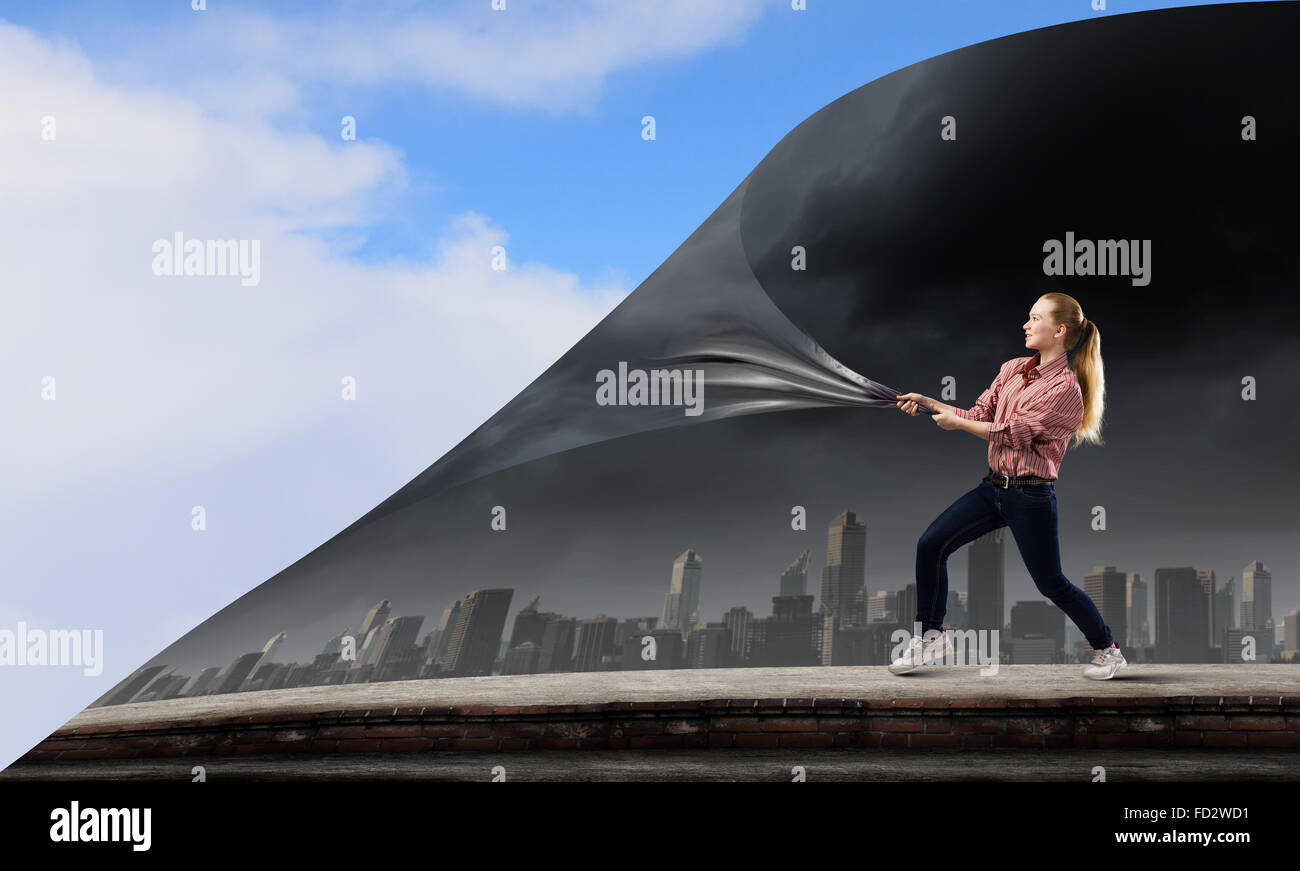 Young woman pulling page to change scene Stock Photo - Alamy