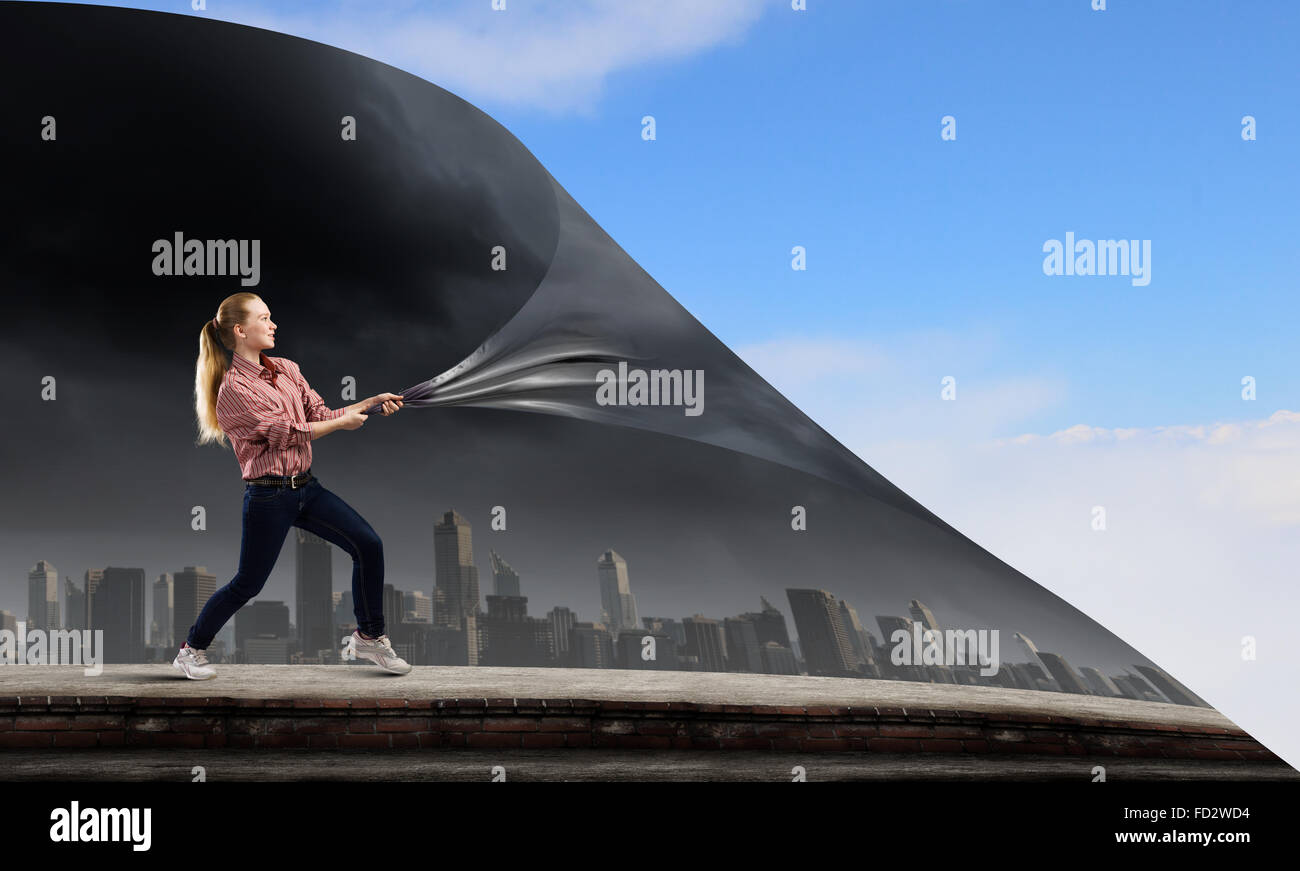 Young woman pulling page to change scene Stock Photo - Alamy