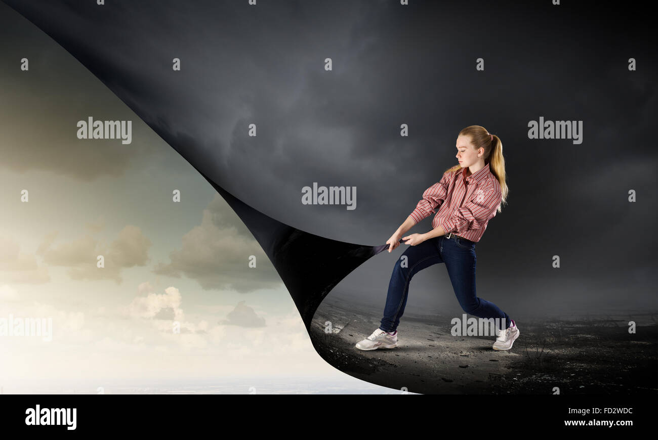 Young woman pulling page to change scene Stock Photo - Alamy