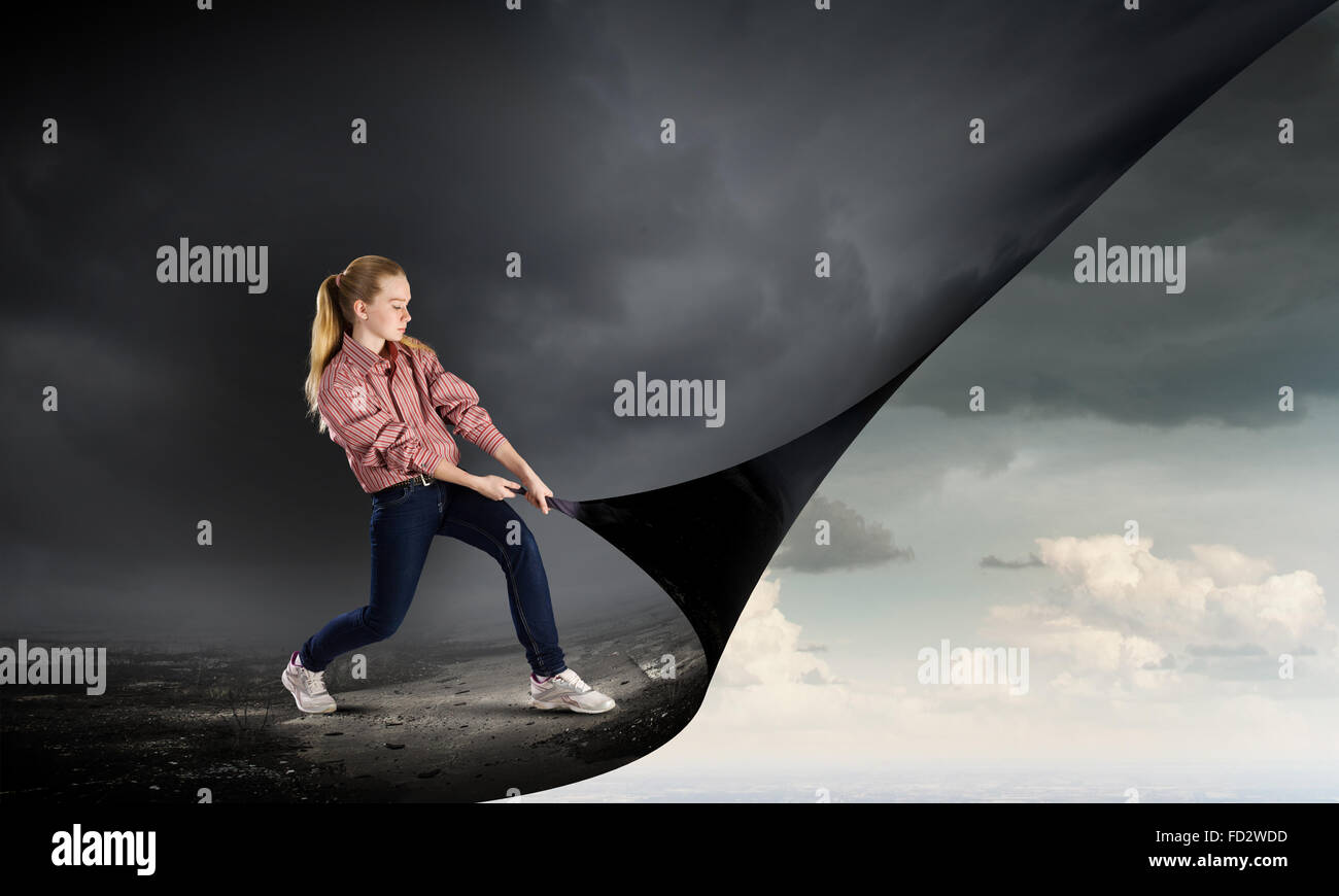 Young woman pulling page to change scene Stock Photo - Alamy