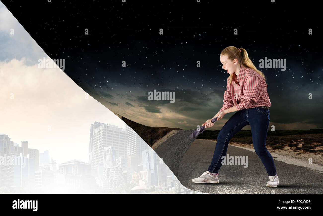 Young woman pulling page to change scene Stock Photo - Alamy