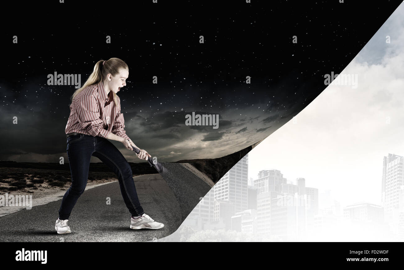 Young woman pulling page to change scene Stock Photo - Alamy