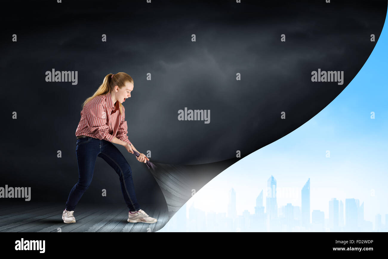 Young woman pulling page to change scene Stock Photo - Alamy
