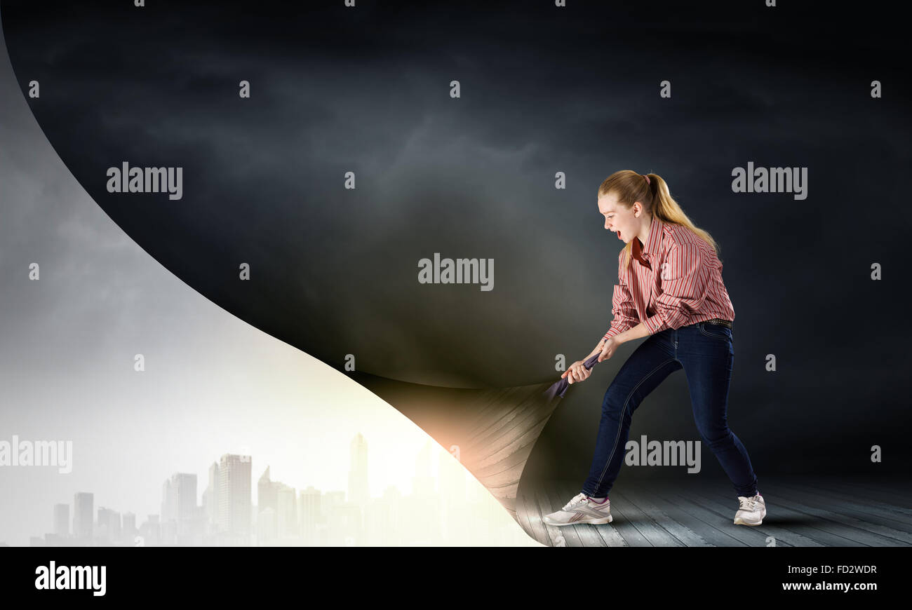 Young woman pulling page to change scene Stock Photo - Alamy
