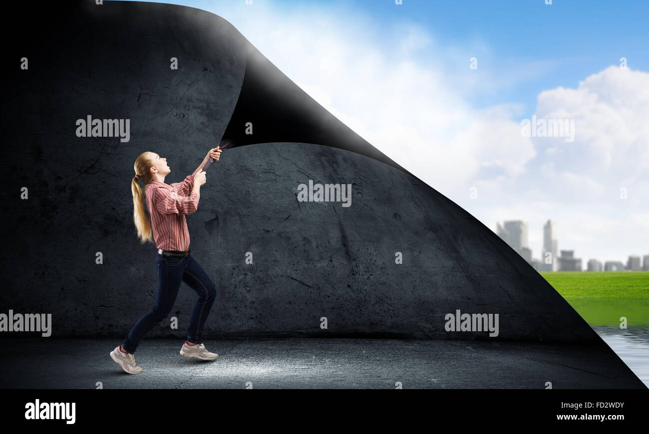 Young woman pulling page to change scene Stock Photo - Alamy