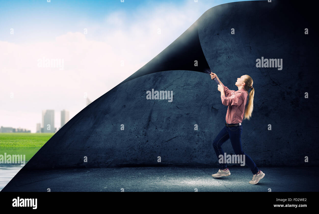 Young woman pulling page to change scene Stock Photo - Alamy