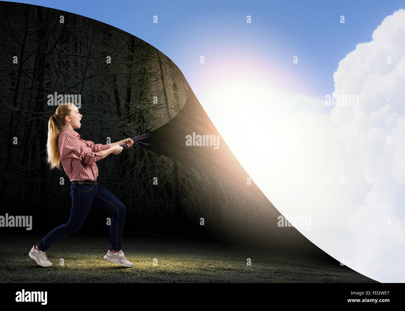 Young woman pulling page to change scene Stock Photo - Alamy