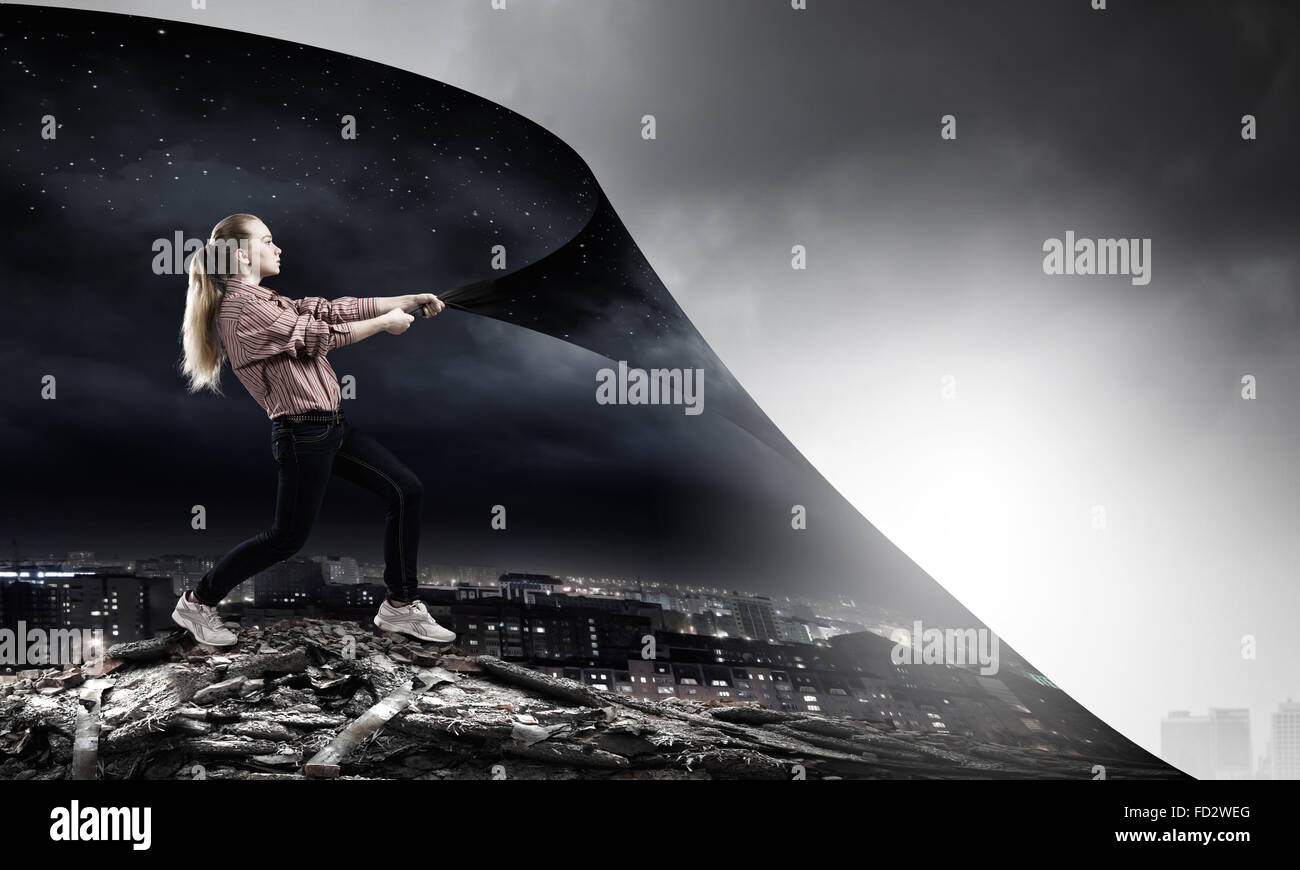 Young woman pulling page to change scene Stock Photo - Alamy