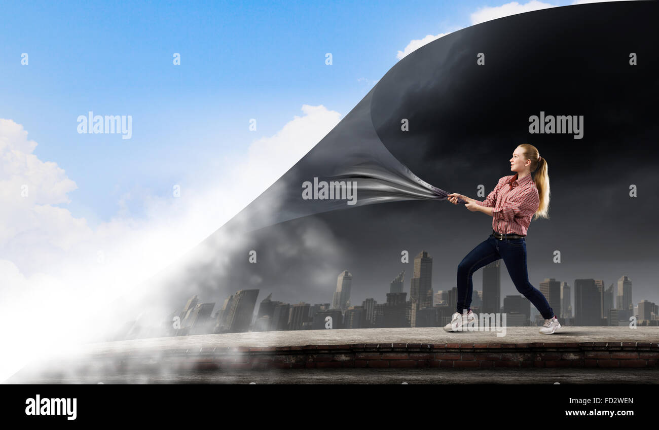 Young woman pulling page to change scene Stock Photo - Alamy