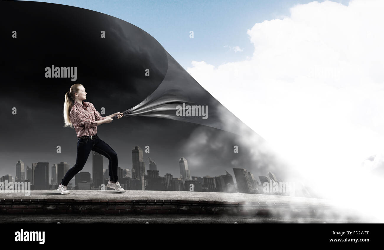 Young woman pulling page to change scene Stock Photo - Alamy