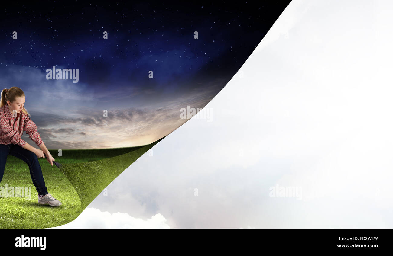 Young woman pulling page to change scene Stock Photo - Alamy