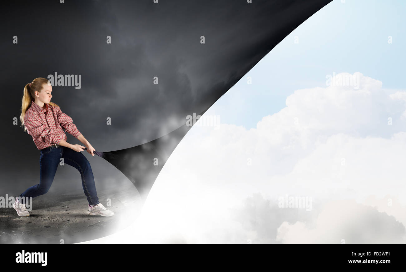 Young woman pulling page to change scene Stock Photo - Alamy