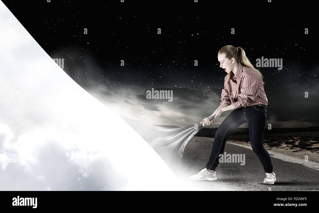 Young woman pulling page to change scene Stock Photo - Alamy