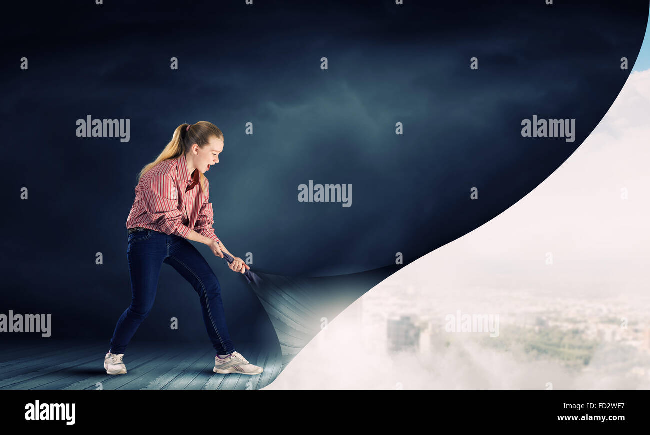 Young woman pulling page to change scene Stock Photo - Alamy