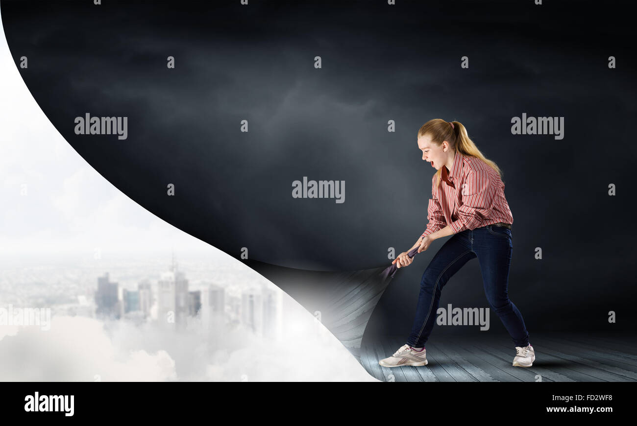 Young woman pulling page to change scene Stock Photo - Alamy