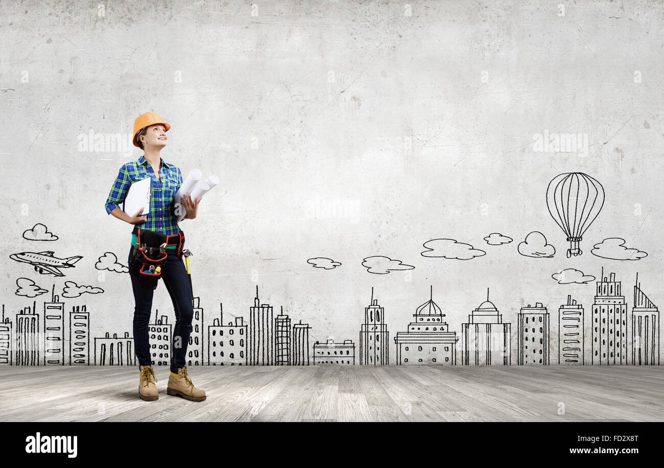 Young woman builder with projects in hand Stock Photo - Alamy