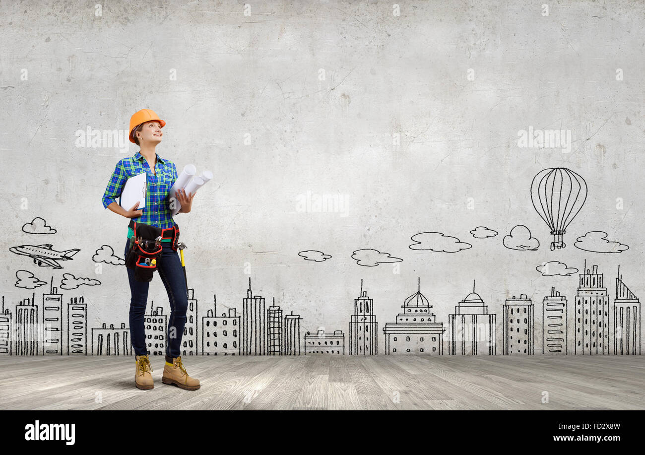 Young woman builder with projects in hand Stock Photo - Alamy
