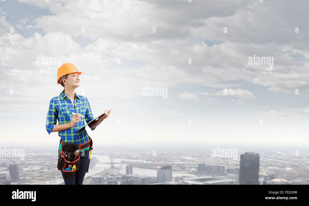 Young woman builder with projects in hand Stock Photo - Alamy