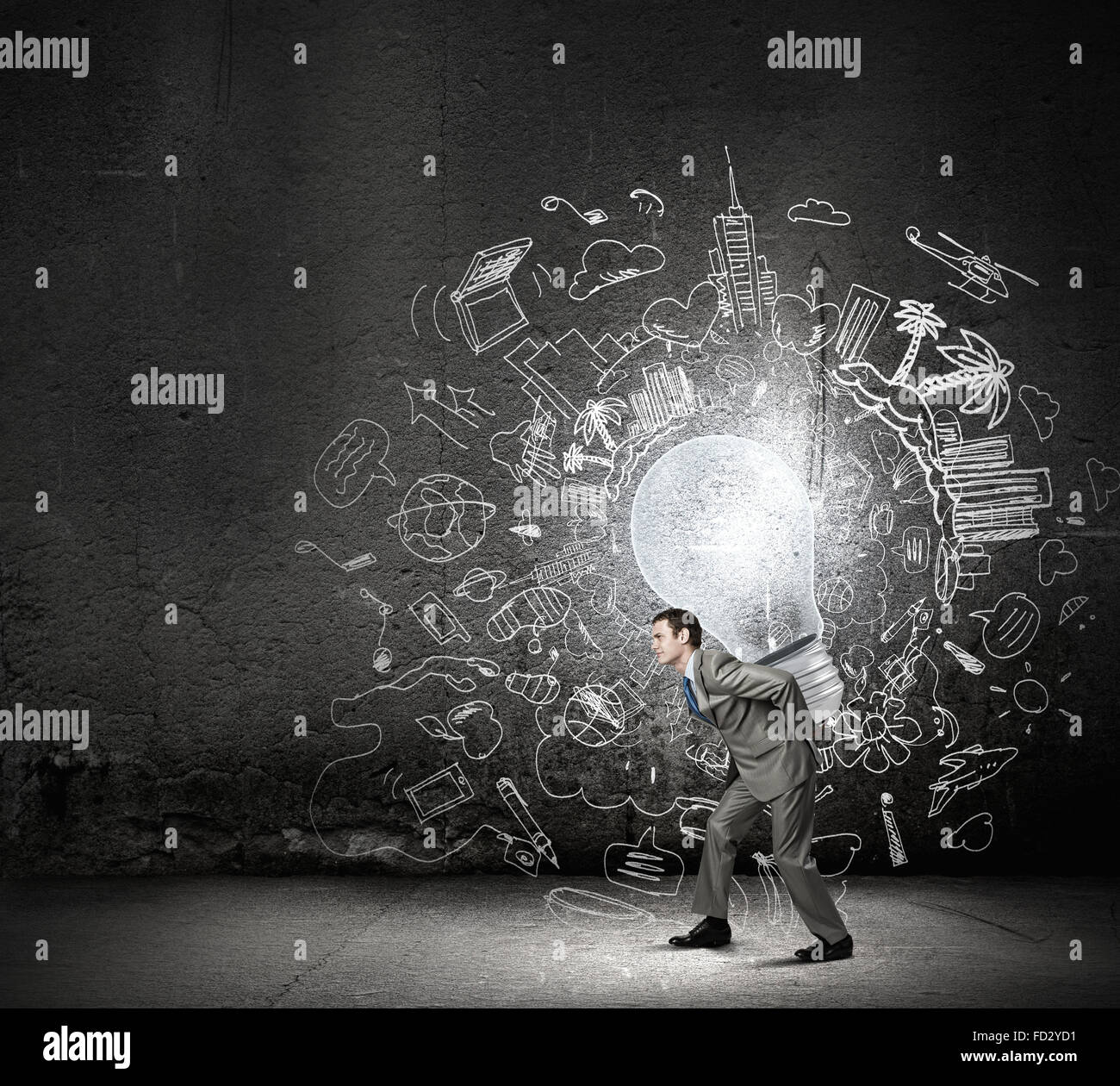 Young businessman carrying light bulb on back Stock Photo - Alamy