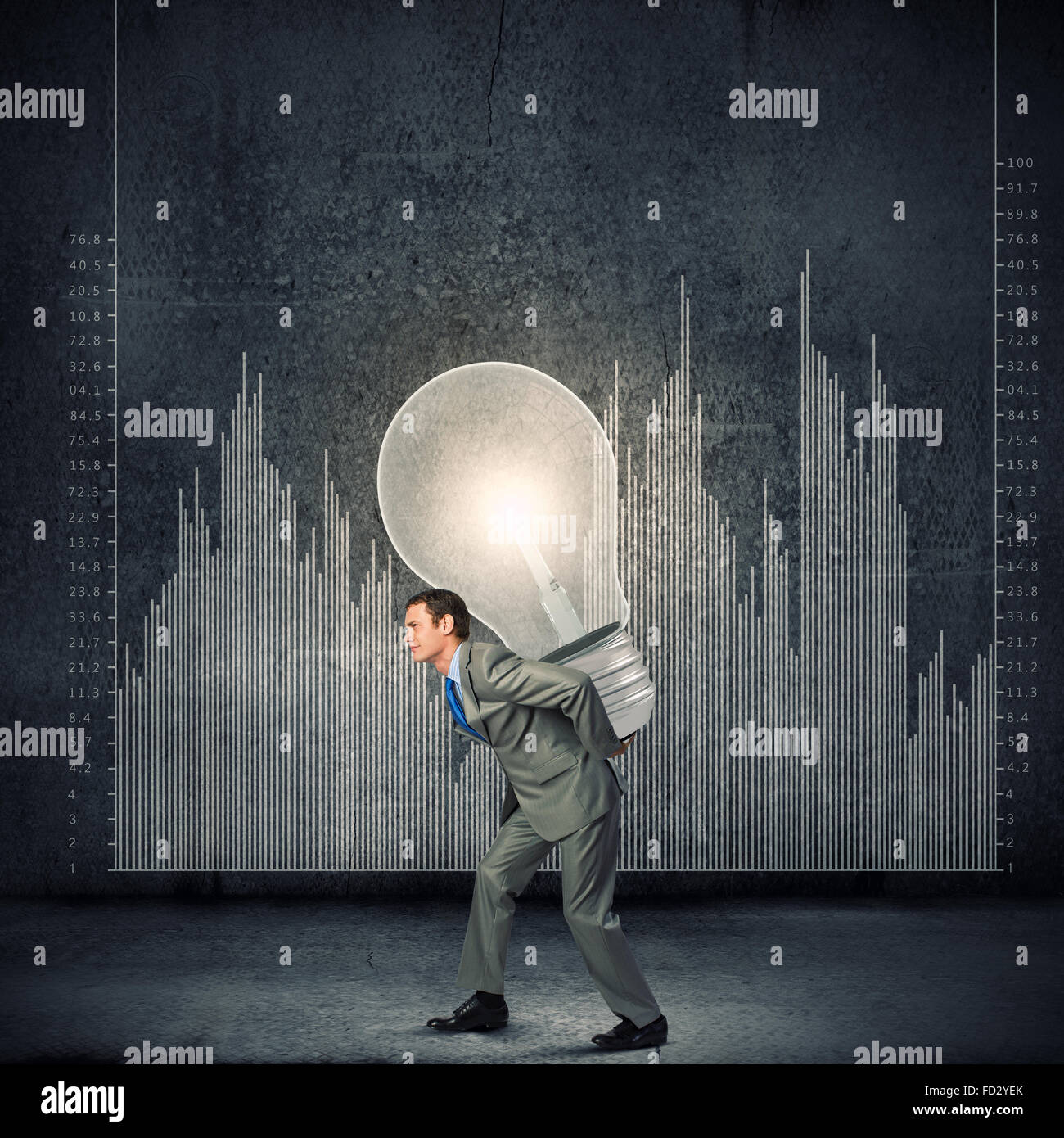 Young businessman carrying light bulb on back Stock Photo - Alamy