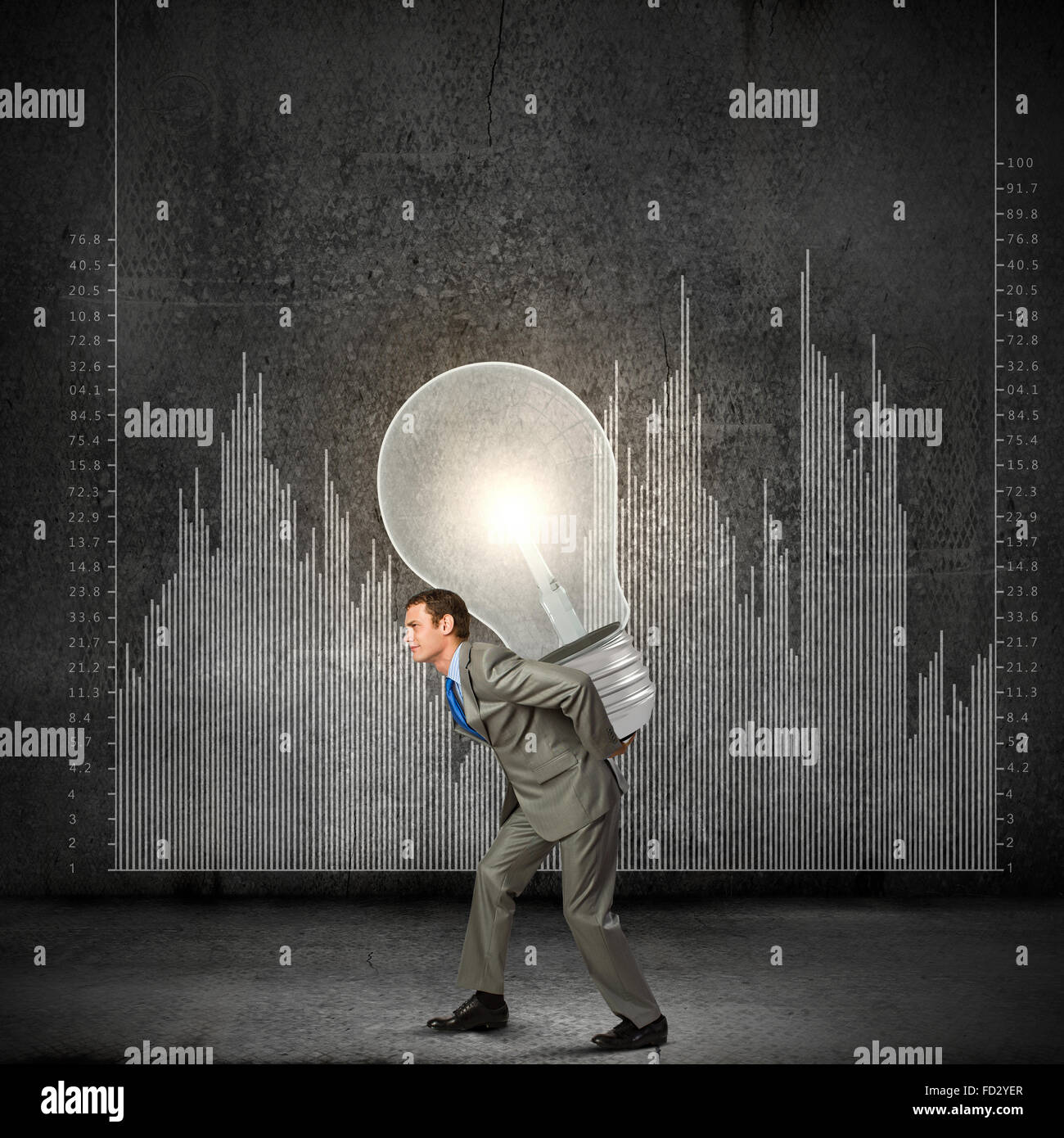Young businessman carrying light bulb on back Stock Photo - Alamy