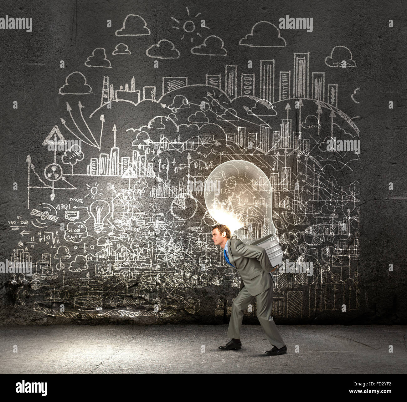 Young businessman carrying light bulb on back Stock Photo - Alamy