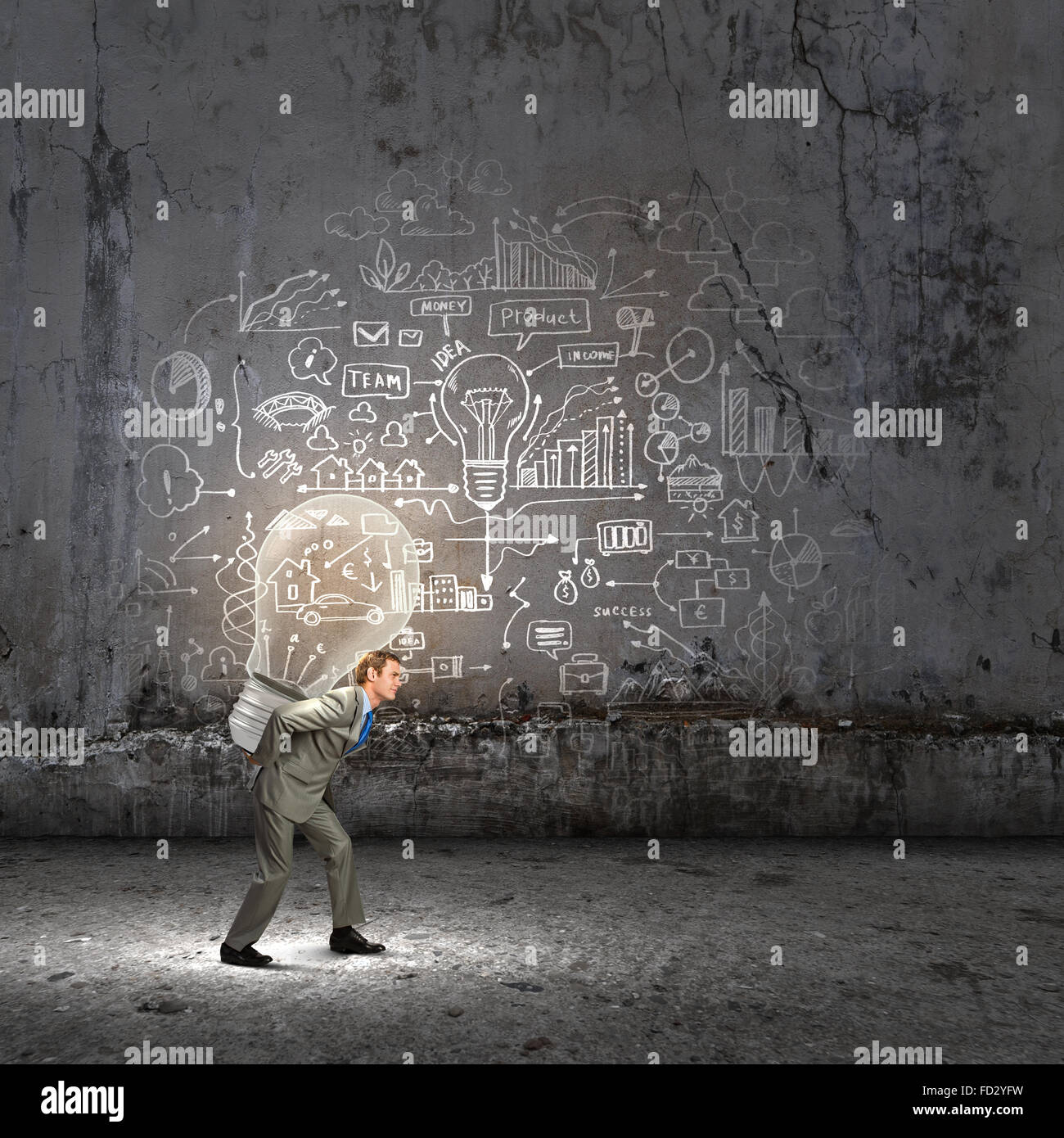 Young businessman carrying light bulb on back Stock Photo - Alamy