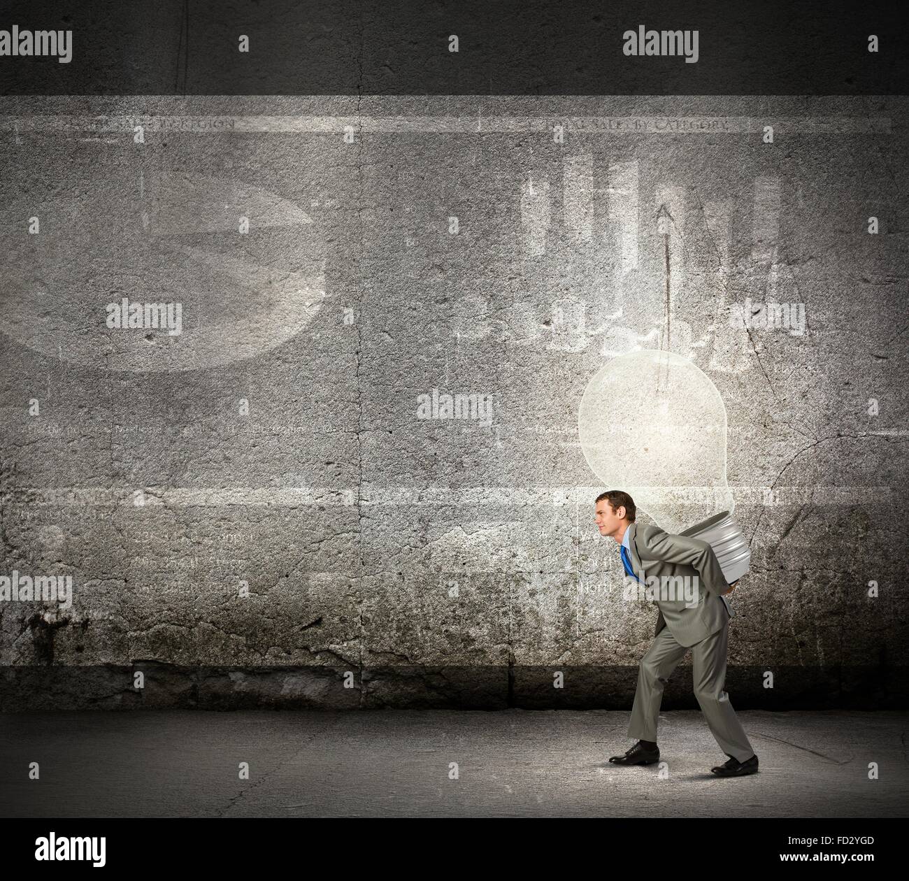Young businessman carrying light bulb on back Stock Photo - Alamy