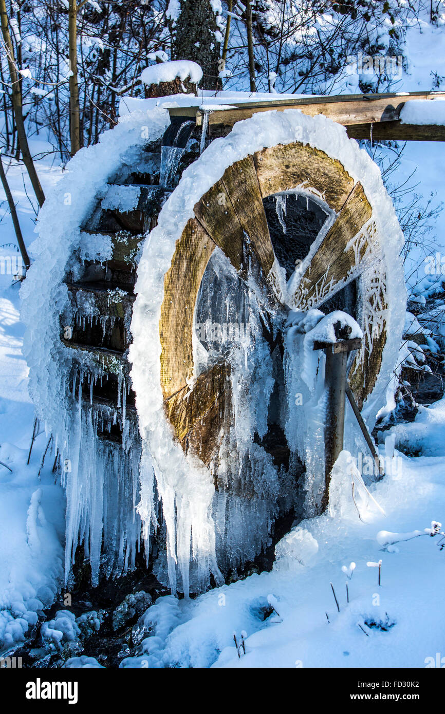 Wooden water wheel, frozen, ice sculptures, icicles along the wheel ...