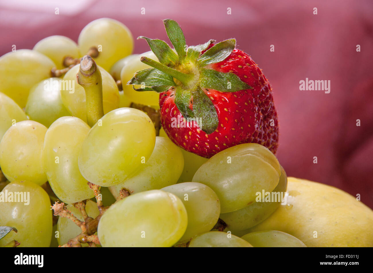a sprig of grapes and strawberries Stock Photo - Alamy