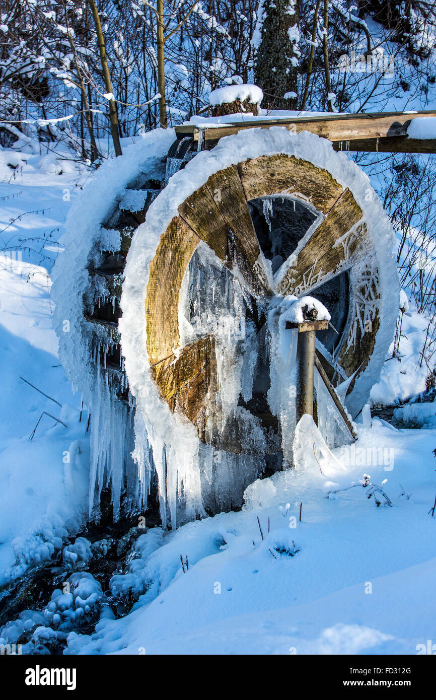 Wooden water wheel, frozen, ice sculptures, icicles along the wheel ...