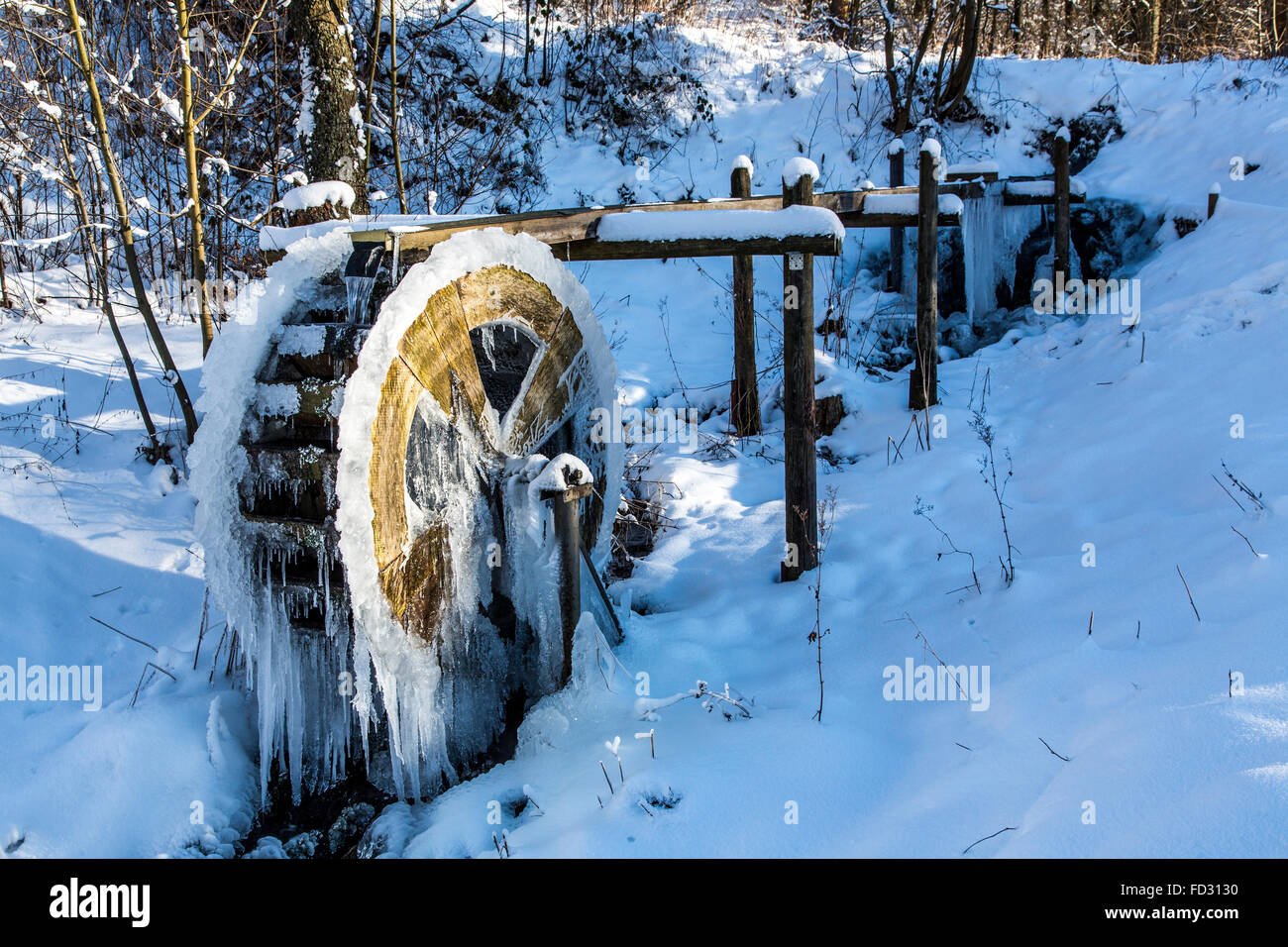 Wooden water wheel, frozen, ice sculptures, icicles along the wheel ...