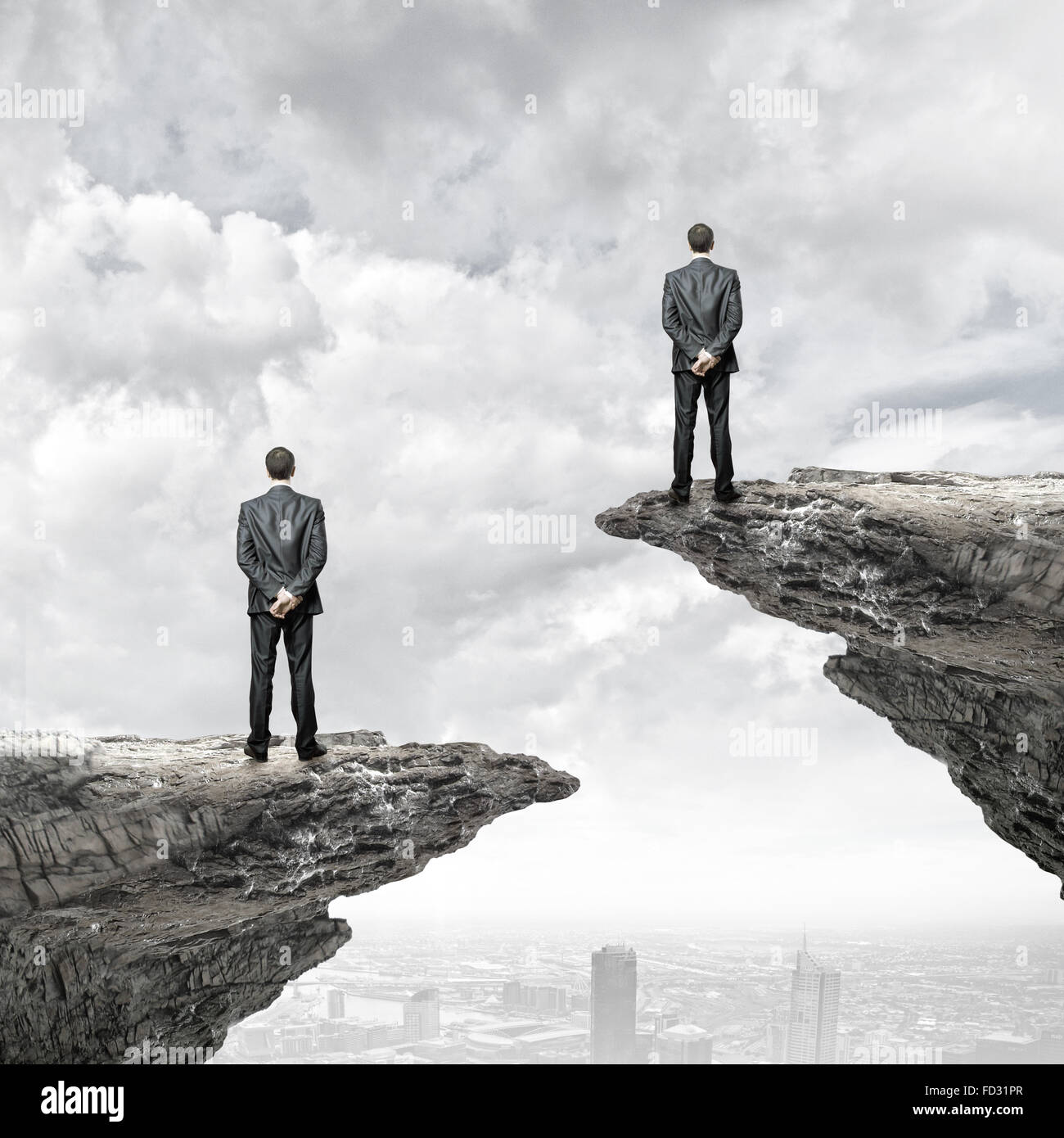 Rear view of businessman standing at rock edge Stock Photo - Alamy