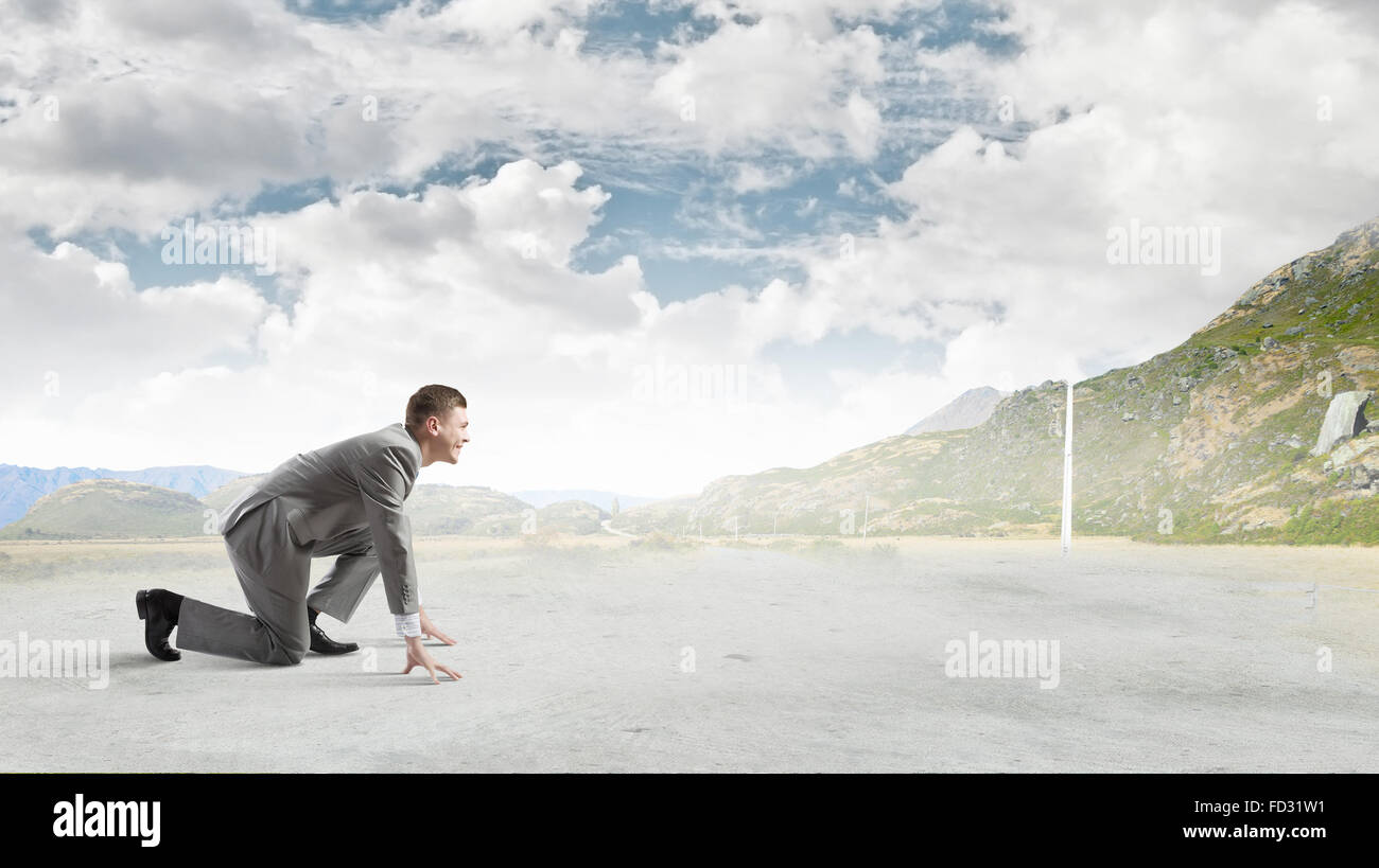Young businessman standing in start pose ready to run hi-res stock ...