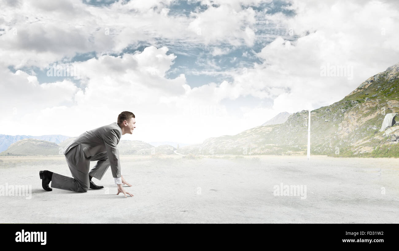 Young businessman standing in start pose ready to run hi-res stock ...