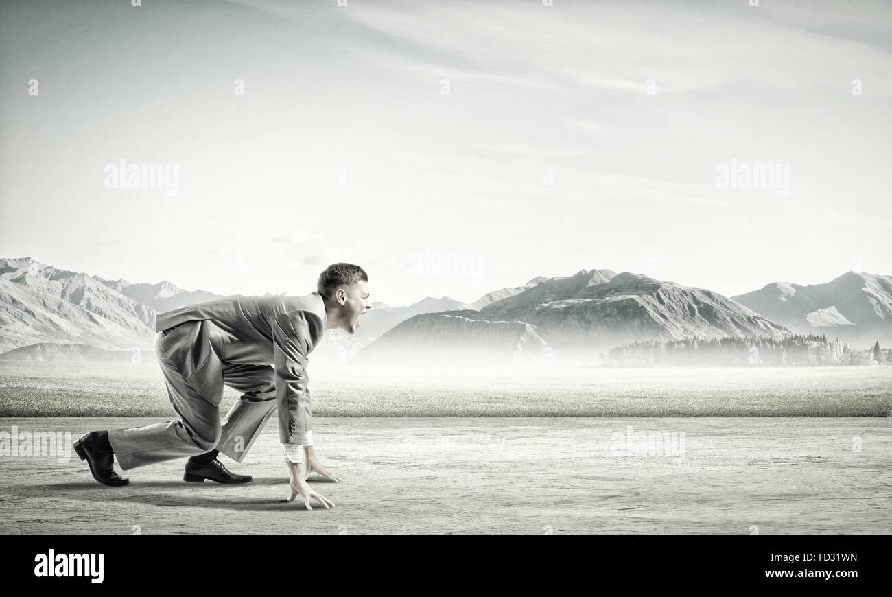 Young businessman standing in start pose ready to run hi-res stock ...