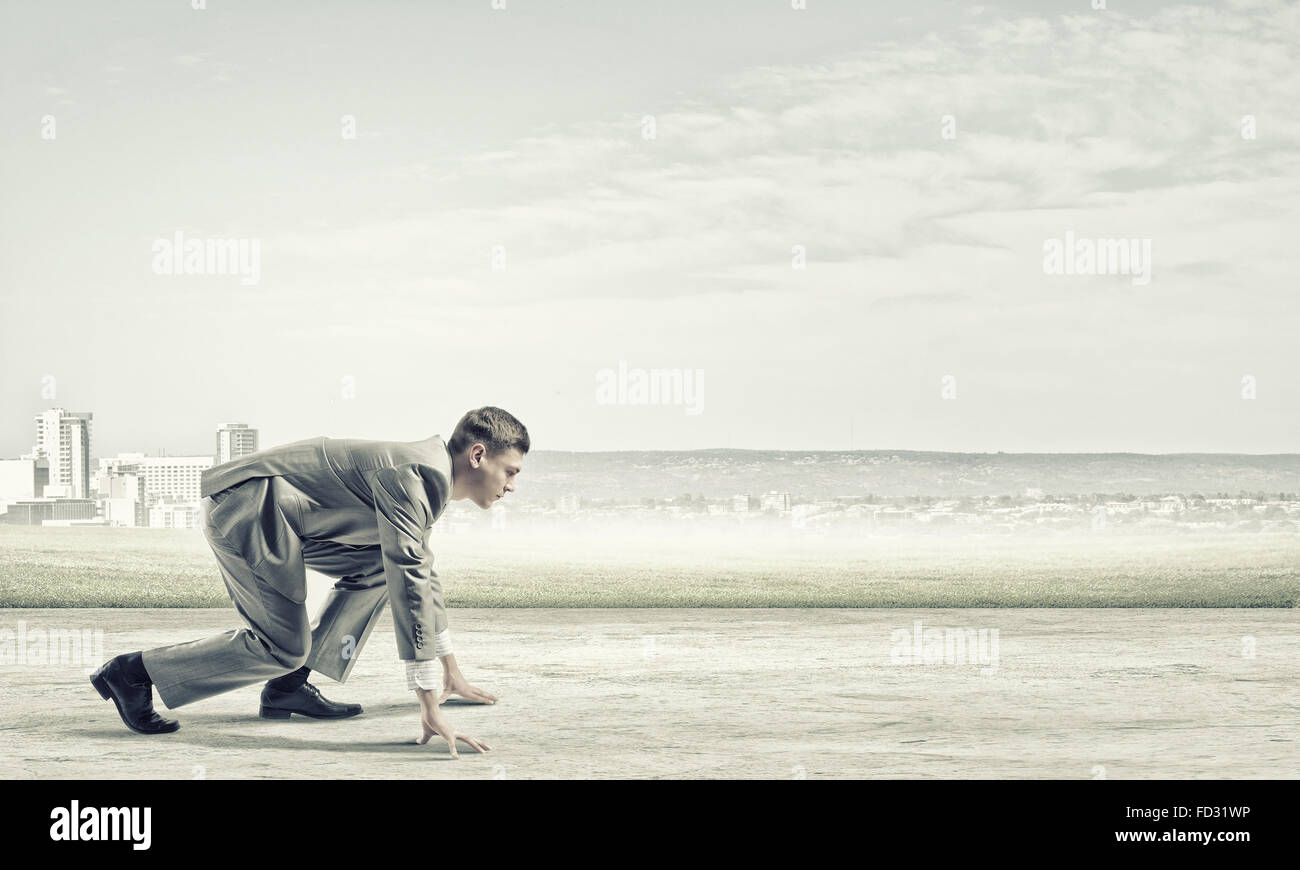 Young businessman standing in start pose ready to run hi-res stock ...