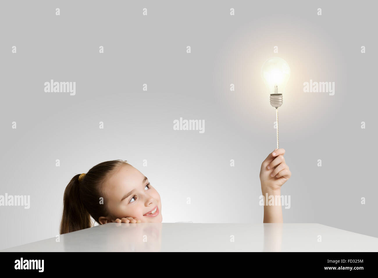 Little cute school girl and electric bulb Stock Photo - Alamy